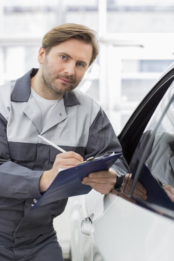 Mechanic Leaning Over Car Window In Garage Stock Photo - Image of chevy ...