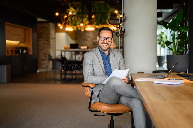 Portrait of Confident Project Manager with Computer and Documents on ...
