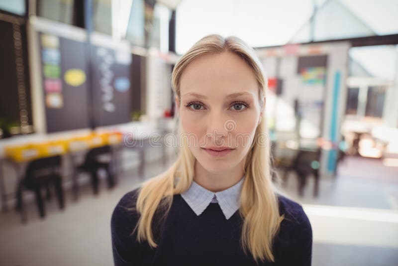 Portrait of Confident Teacher Standing in Classroom Stock Photo - Image ...
