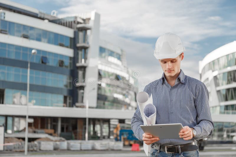 Portrait of Confident Young Architect or Chief Engineer Uses Digital ...