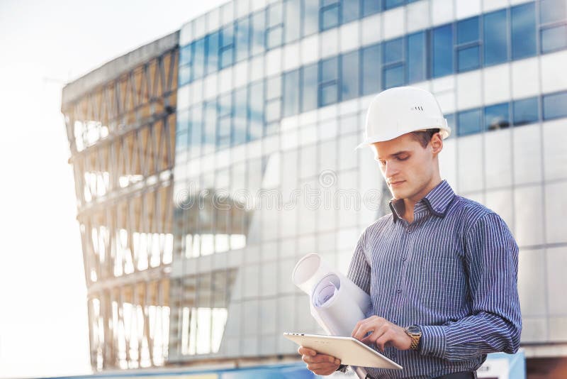 Portrait of Confident Young Architect or Chief Engineer Uses Digital ...