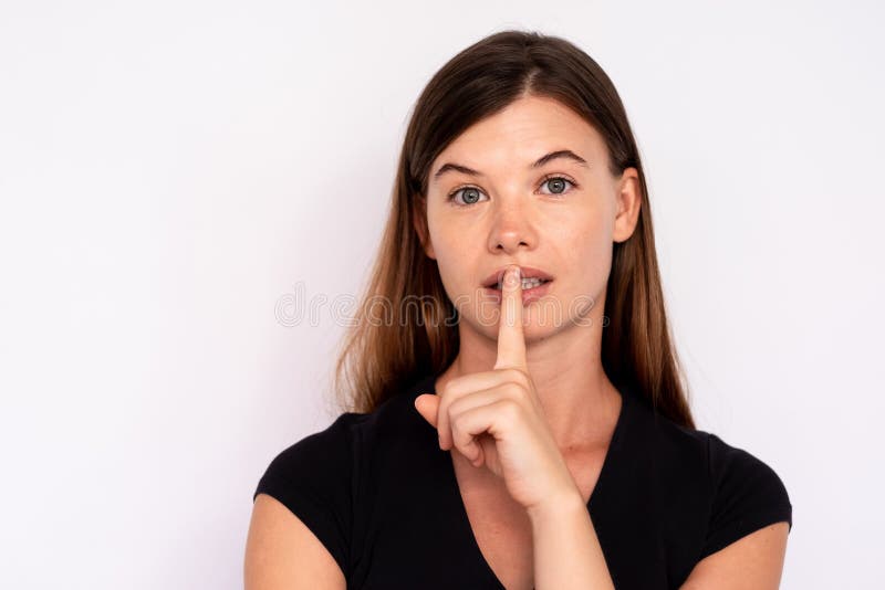 Portrait of Confident Young Woman Standing with Finger on Lips Stock ... Portrait of Confident Young Woman Standing with Finger on Lips Stock ...