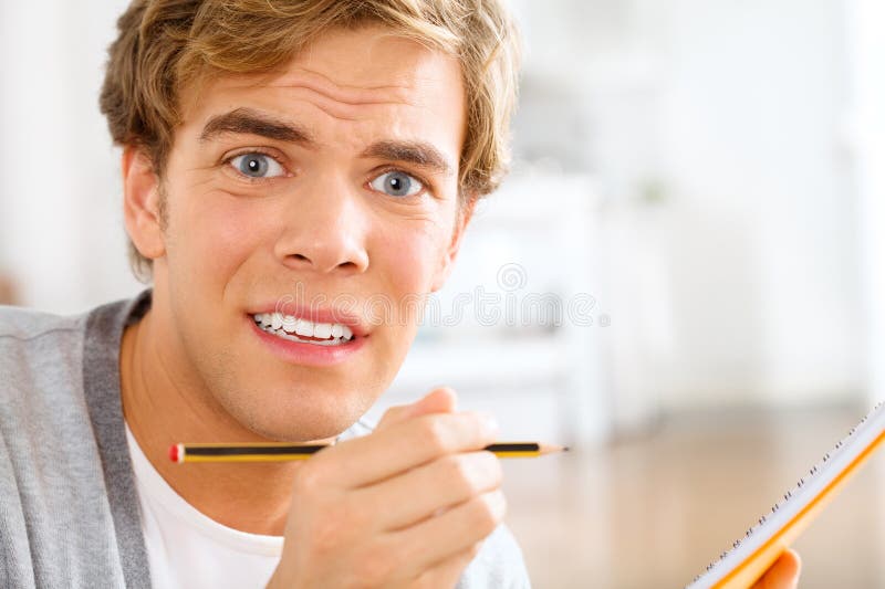 Portrait, Confused and Man Writing Notes in Classroom for Studying ...