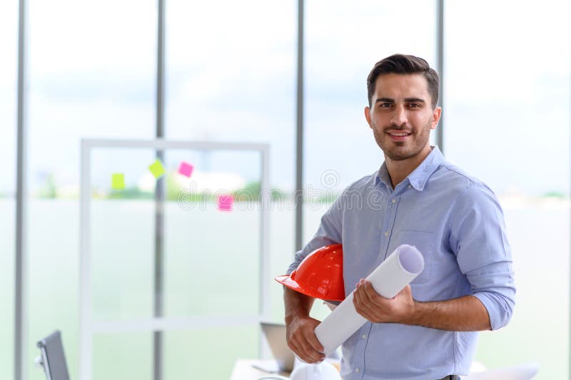 Portrait of Construction Engineer Manager Holding Orange Hardhat and ...