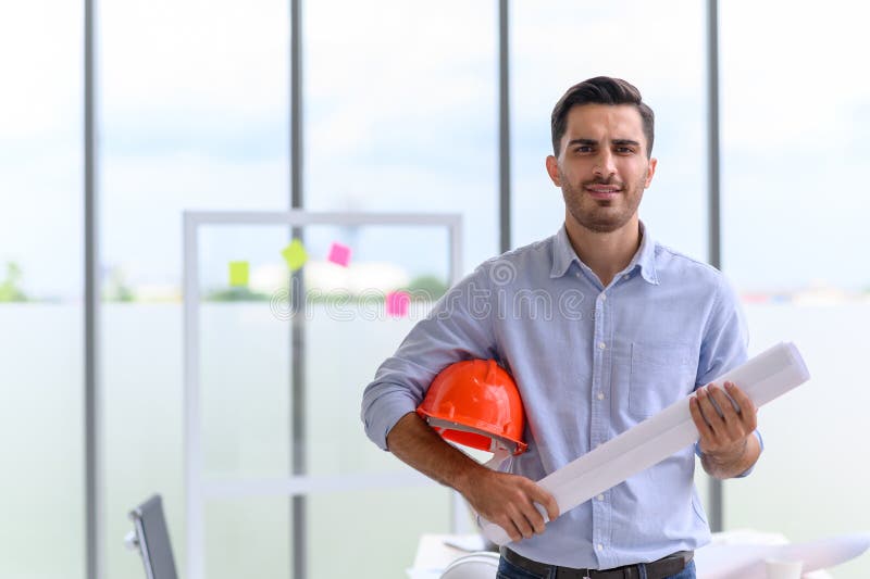 Portrait of Construction Engineer Manager Holding Orange Hardhat and ...