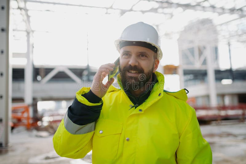 Portrait of Construction Foreman Making Phone Call in Modern Building ...