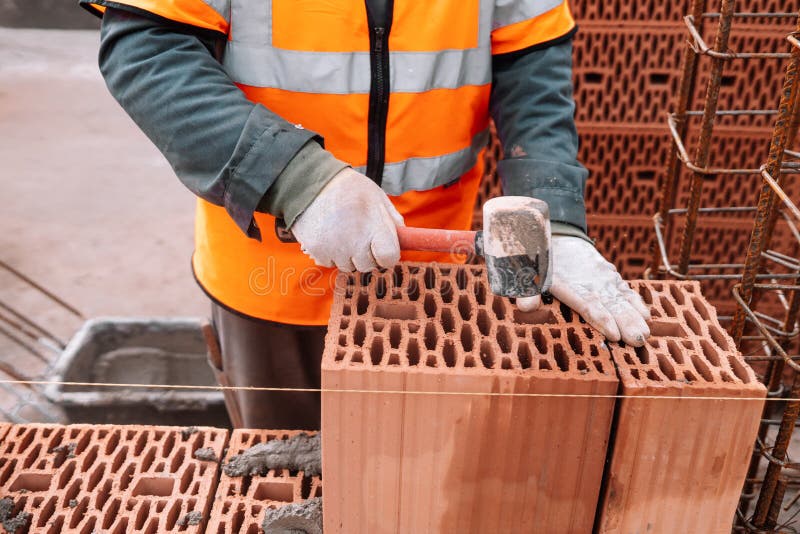 Industrial Bricklayer Installing Bricks on Construction Site Stock ...