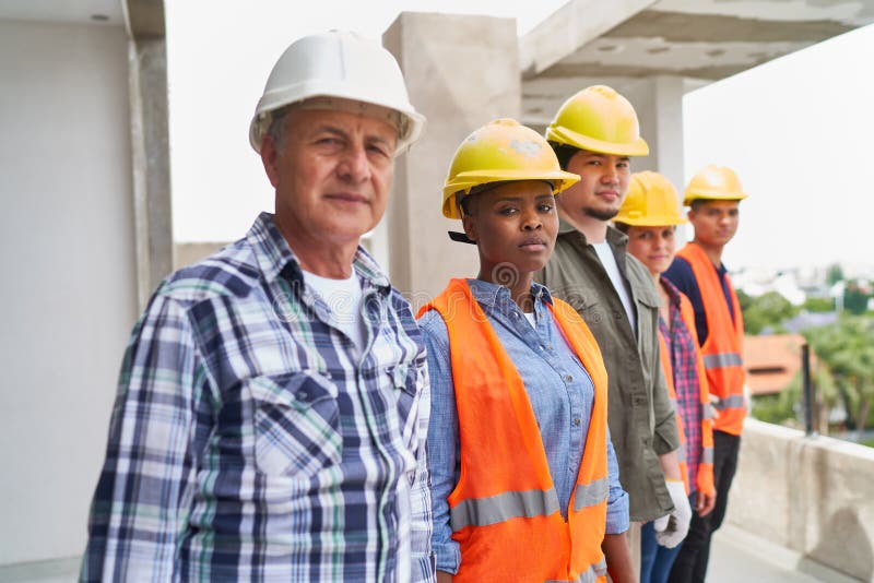Portrait of Construction Team in Workwear Standing Together at ...