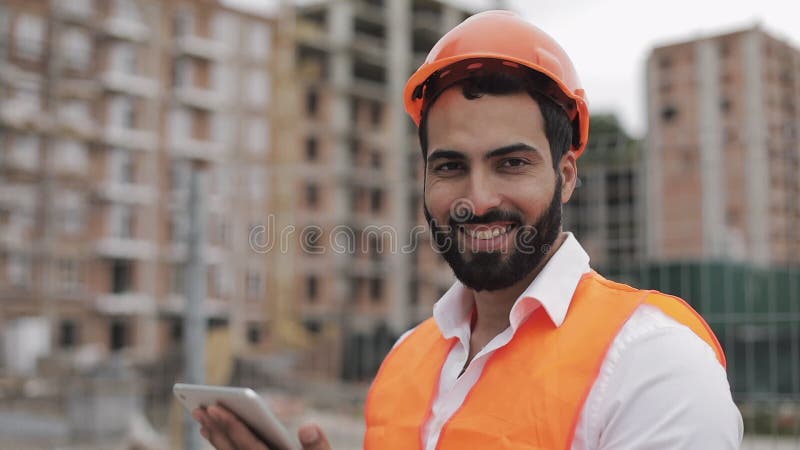Portrait of Construction Worker on Building Site with Tablet Looking at ...