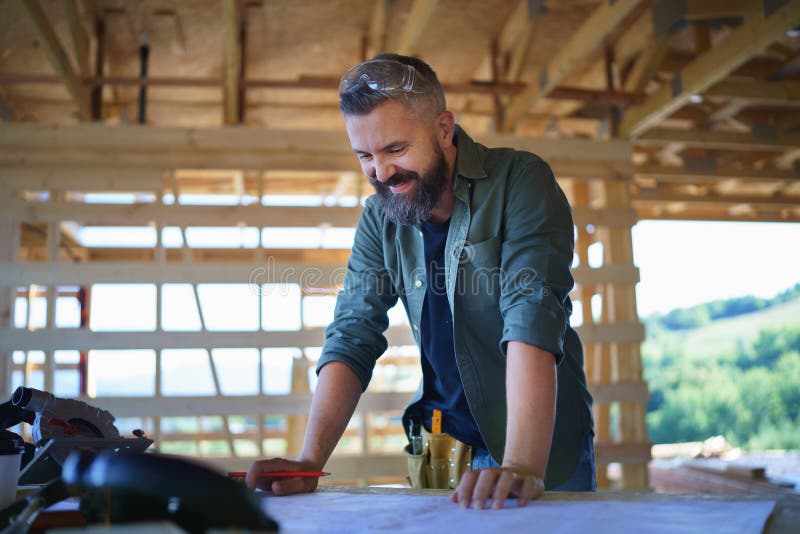 Portrait of Construction Worker Smiling and Checking Blueprints, Diy ...
