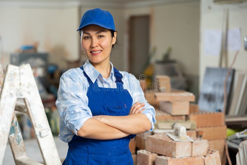 Portrait of Contented Female Foreman of Construction Team Inside ...