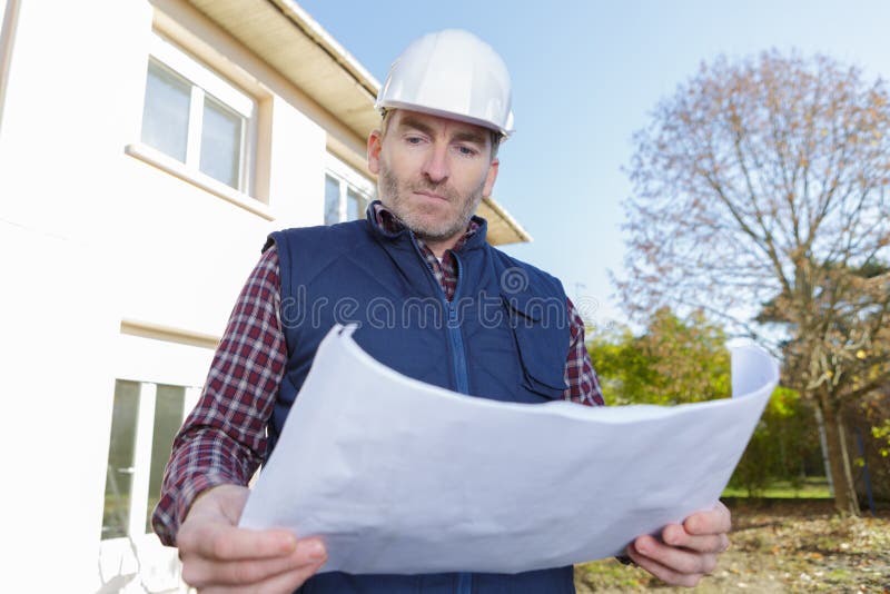 Portrait Contractor Holding Blueprints Outdoors Stock Photo - Image of ...