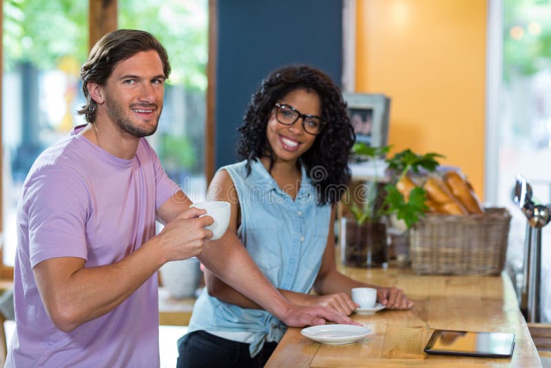 Portrait of Couple Smiling while Having Coffee at Counter Stock Photo ...