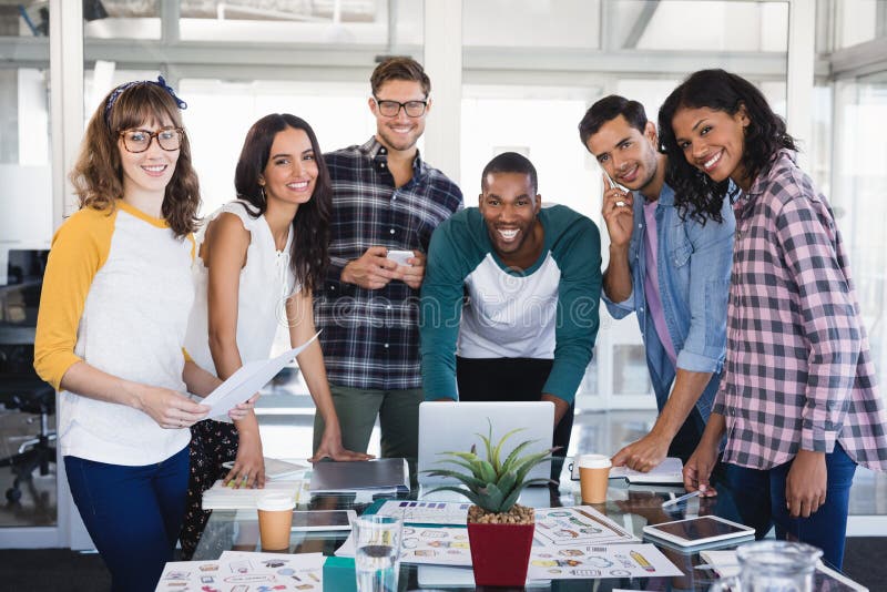 Portrait of Creative Business Team Standing Around Table Stock Photo ...