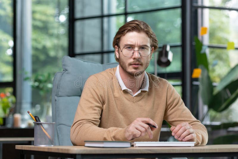 Portrait of a Creative Office Worker Sitting at a Table with a Computer ...