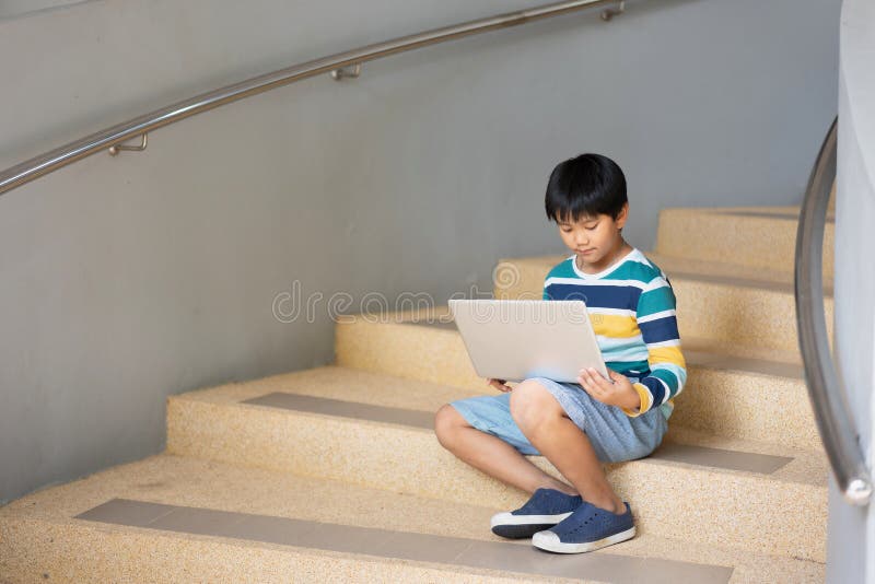 Portrait of Cute Asian Boy Studying or Playing Game with Laptop ...