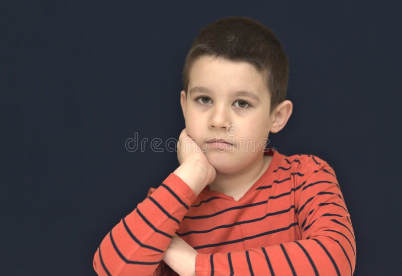 Portrait of a Cute Boy Looking Doubtful. Stock Photo - Image of ...