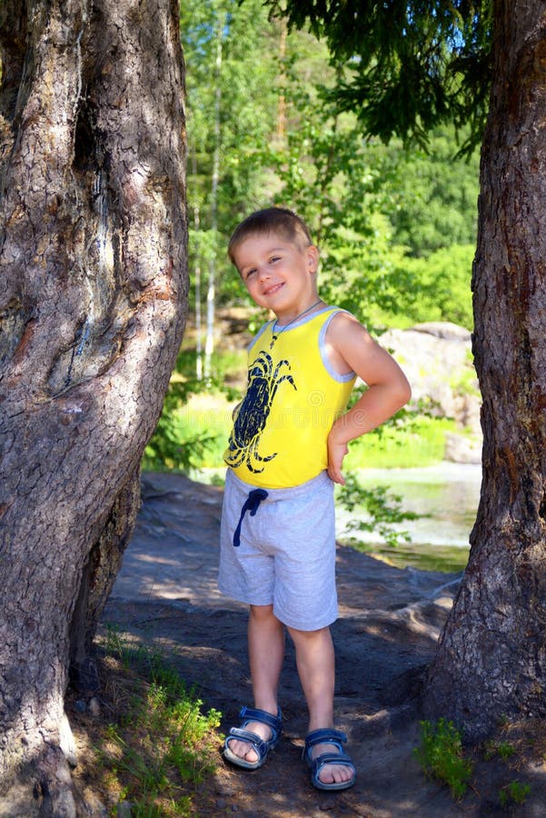 Portrait of a Cute Boy Posing Near Tree Stock Photo - Image of face ...
