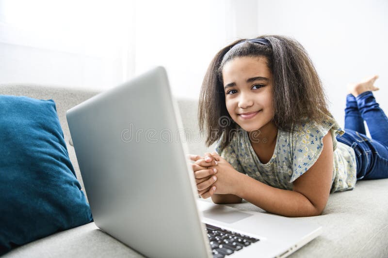 Portrait of Cute Child Using Laptop on Sofa Stock Photo - Image of ...
