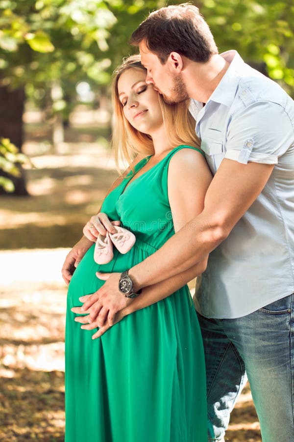 Portrait of a Cute Expectant Parents in Park Stock Image - Image of ...