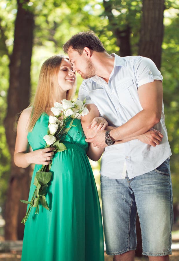 Portrait of a Cute Expectant Parents in Park Stock Image - Image of ...