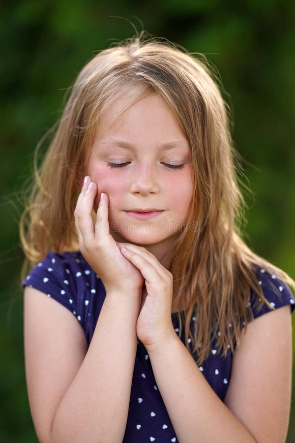 Portrait Of A Cute Gentle Girl With Long Hair And Closed Eyes Stock