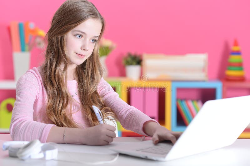 Portrait of Cute Girl Using Laptop at Desk Stock Photo - Image of ...
