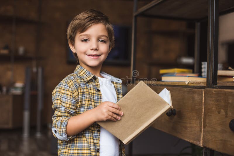 Portrait of Cute Little Boy with Book in Hands Looking at Camera Stock ...