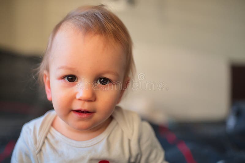 Cute Little Boy Sitting on a Bed Stock Image - Image of head, little ...
