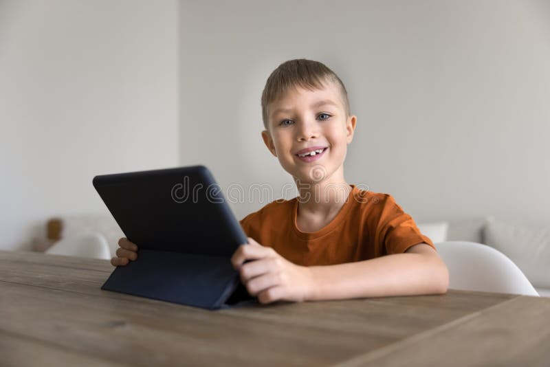 Portrait of Cute Little Boy Sitting at Table with Tablet Stock Image ...