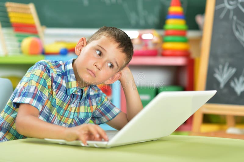 Portrait of Cute Little Boy Using Laptop in Classroom Stock Photo ...