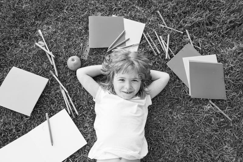 Portrait of Cute Smart Clever School Boy Nerd Doing Homework, Lie on ...