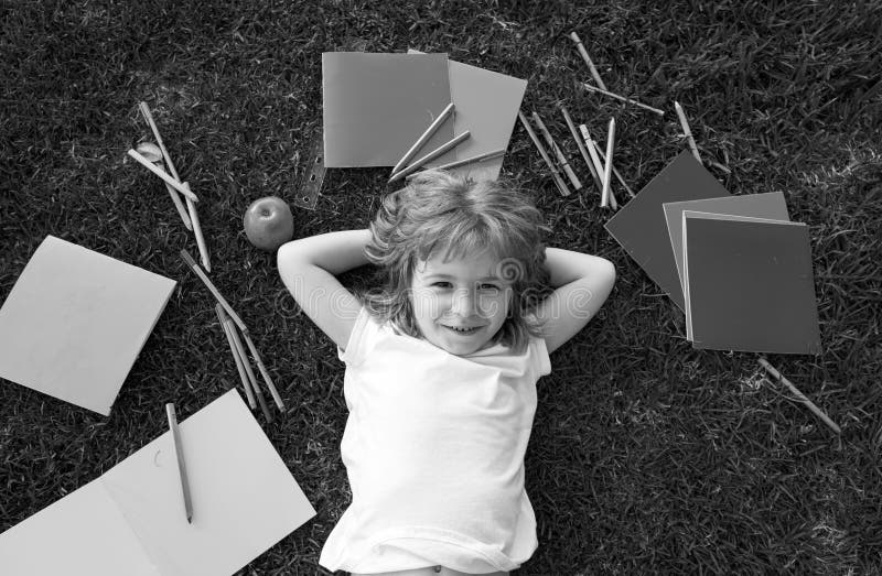 Portrait of Cute Smart Clever School Boy Nerd Doing Homework, Lie on ...