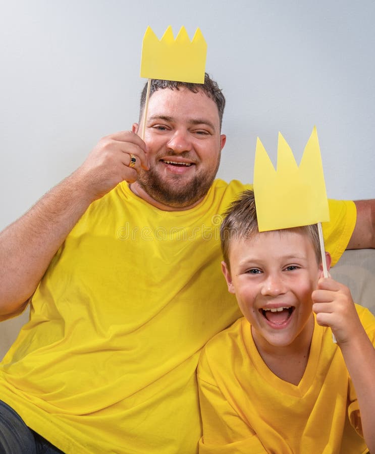 Portrait of Dad and Son in Yellow Clothes and with Crowns Stock Photo ...