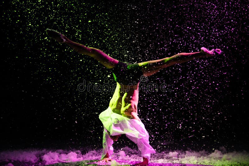 Portrait of a Dancer in an Acrobatic Pose on a Black Background with ...