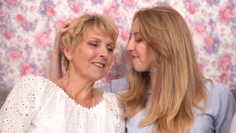 Portrait Of A Daughter And An Elderly Mother Her Daughter Kisses Her