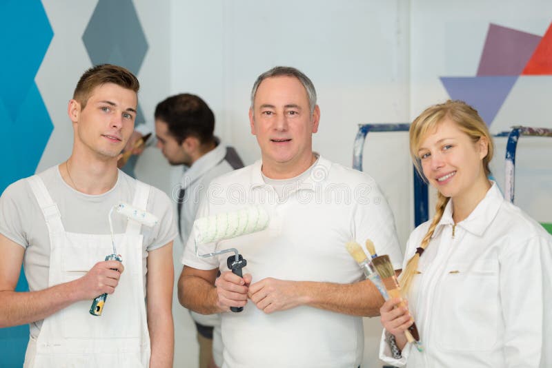 Portrait Decorating Team Holding Brushes and Roller Stock Image - Image ...