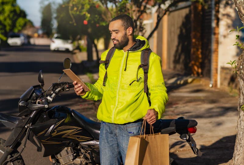 Portrait of Delivery Man with His Motorcycle with Delivery. Parcel ...