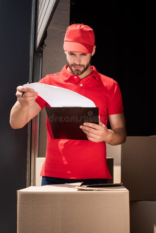 Portrait of Delivery Man in Uniform Checking Notes Stock Photo - Image ...