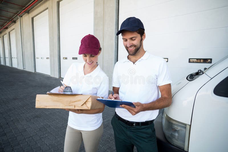 Portrait of Delivery People are Smiling and Looking Clipboards Stock ...