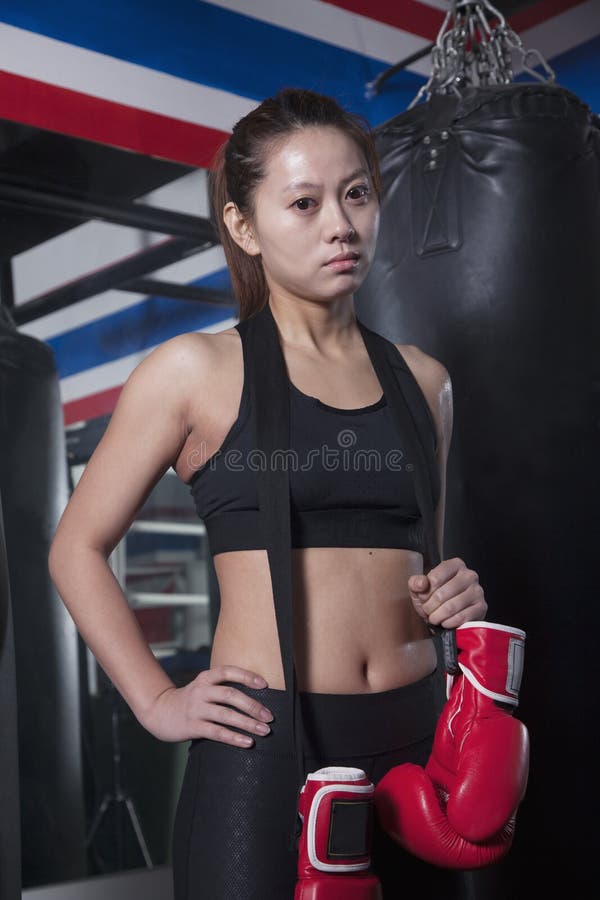 Portrait of Determined Female Boxer in Fighting Stance Looking at ...