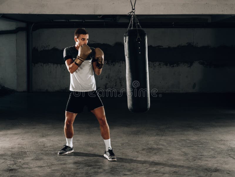 Strength Male Boxer Training with Punching Bag. Boxing Exercise Stock ...