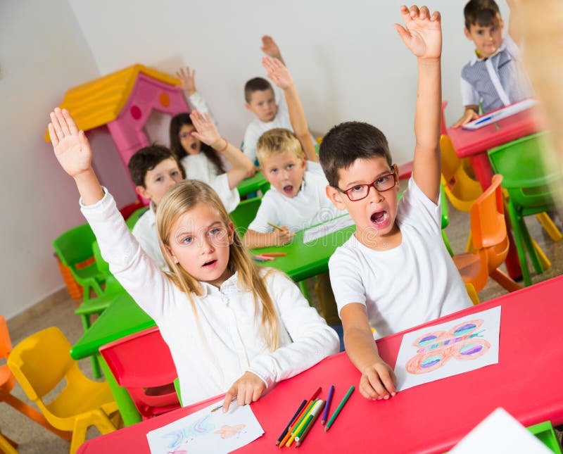 Diligent Schoolchildren with Hands Raised Stock Photo - Image of hands ... Diligent Schoolchildren with Hands Raised Stock Photo - Image of hands ...