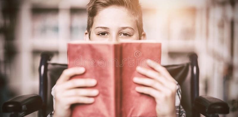 Portrait of Disabled Schoolboy Holding Book in Library Stock ... Portrait of Disabled Schoolboy Holding Book in Library Stock ...