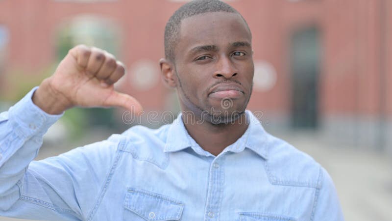 Portrait of Disappointed African Man Doing Thumbs Down Stock Image ...