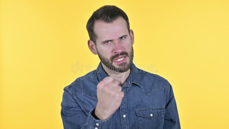The Portrait of Disappointed Young Man Feeling Angry, Yellow Background ...