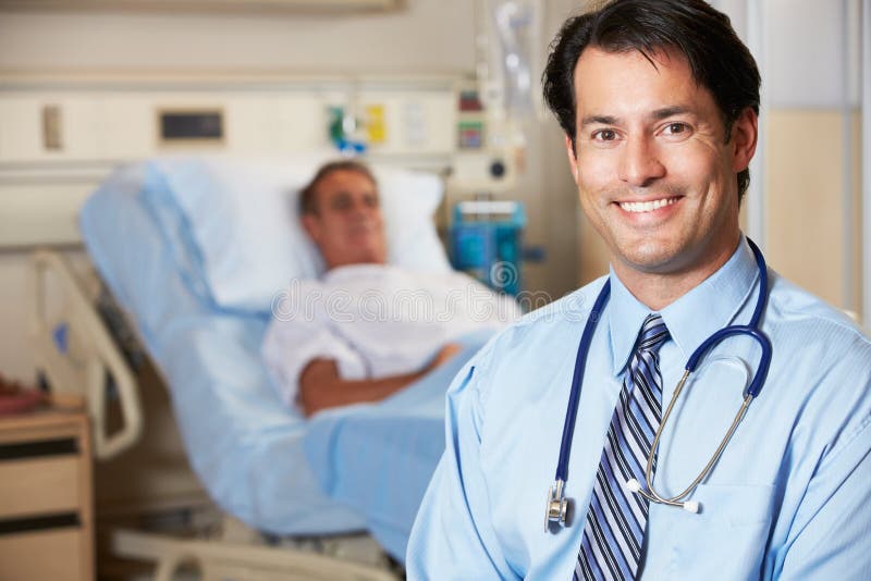 Portrait of Doctor with Patient in Background Stock Photo - Image of ...
