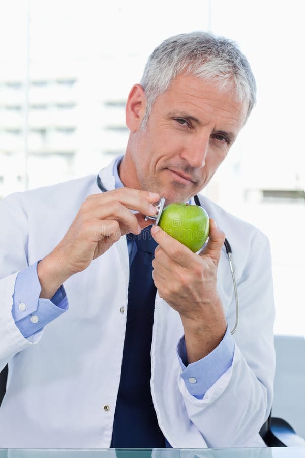 Portrait of a Doctor Putting His Stethoscope on an Apple Stock Image ...