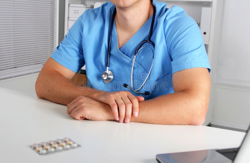 Portrait of a Doctor with Stethoscope Sits by the Table. Stock Image ...