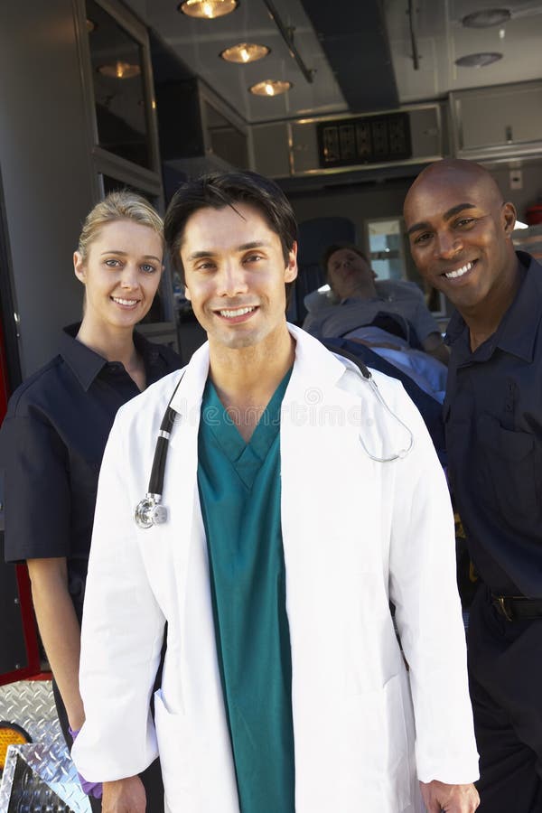 Paramedics and Doctor Unloading Patient Stock Photo - Image of people ...